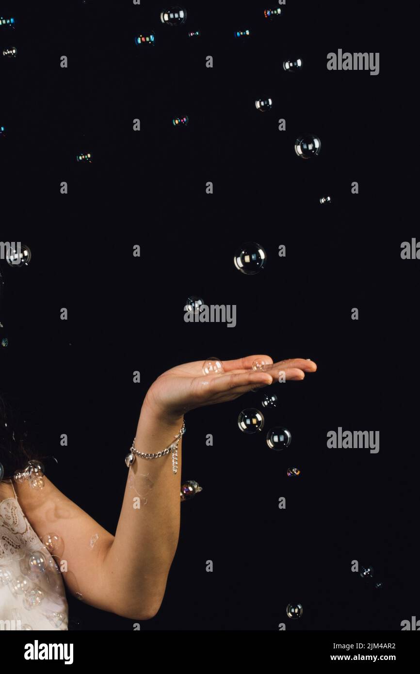 Woman's arm with flattened hand gesturing to floating, touchable ...