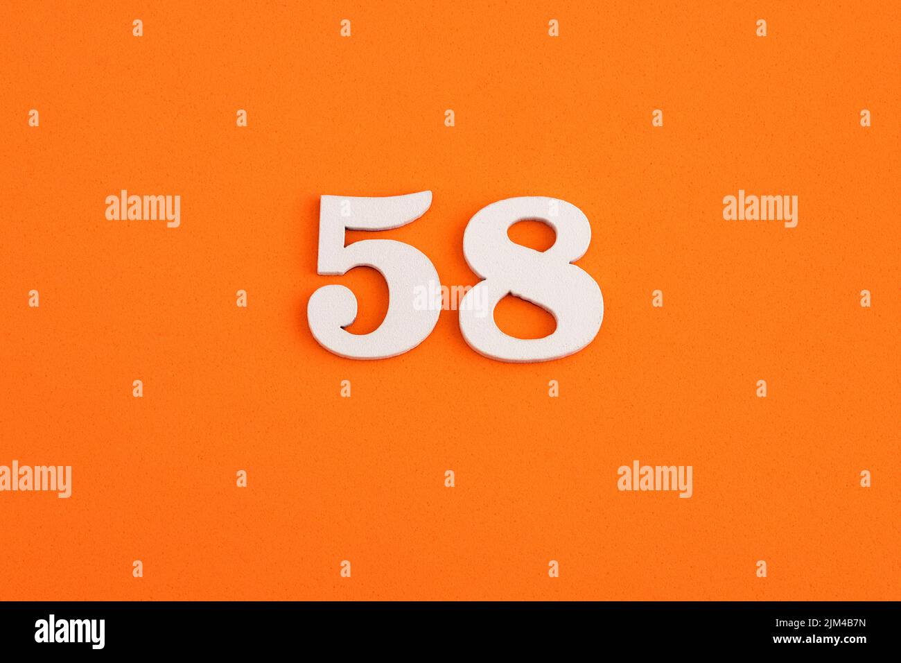 White wooden number 58 on eva rubber orange background Stock Photo - Alamy
