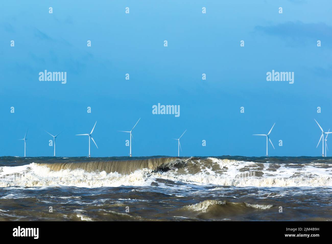 Offshore windmill park in a stormy north sea with spindrift waves Stock ...