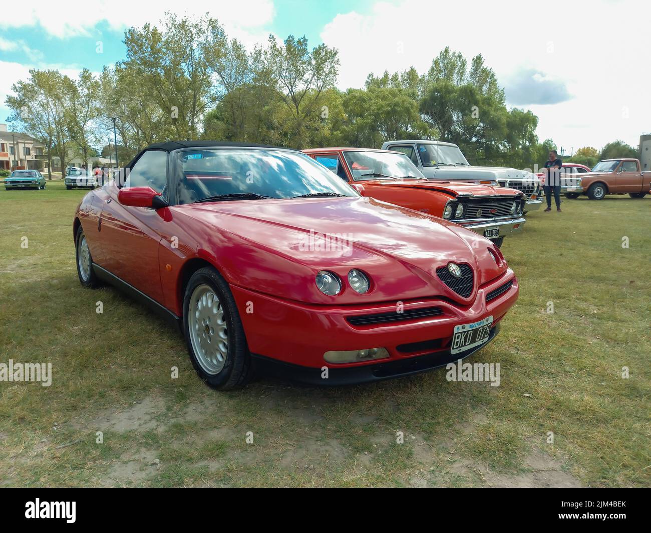 Red sport Alfa Romeo Spider Type 916 roadster early 1990s parked on the ...