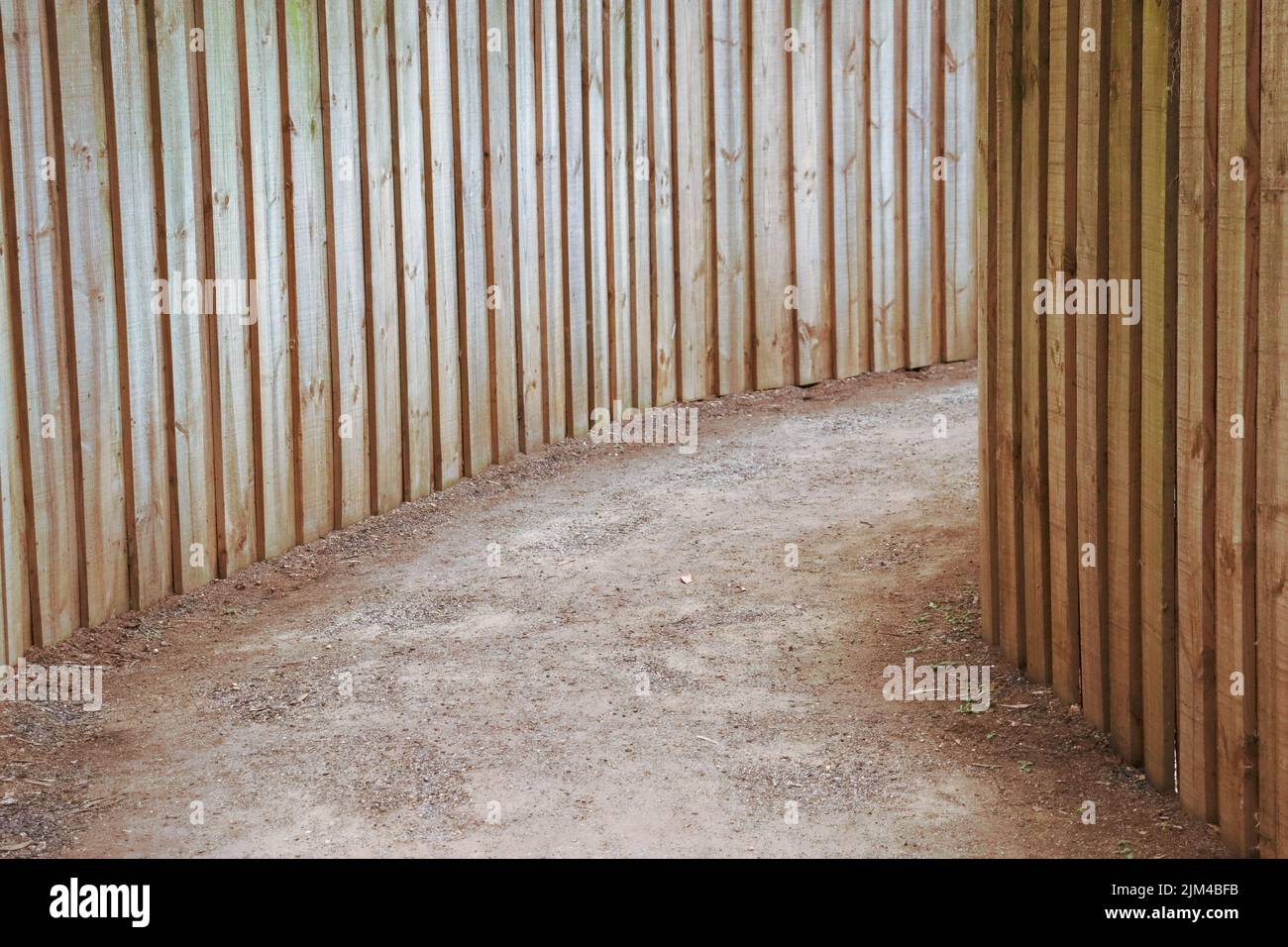 outdoor dirt walking path lined with timber boards Stock Photo - Alamy