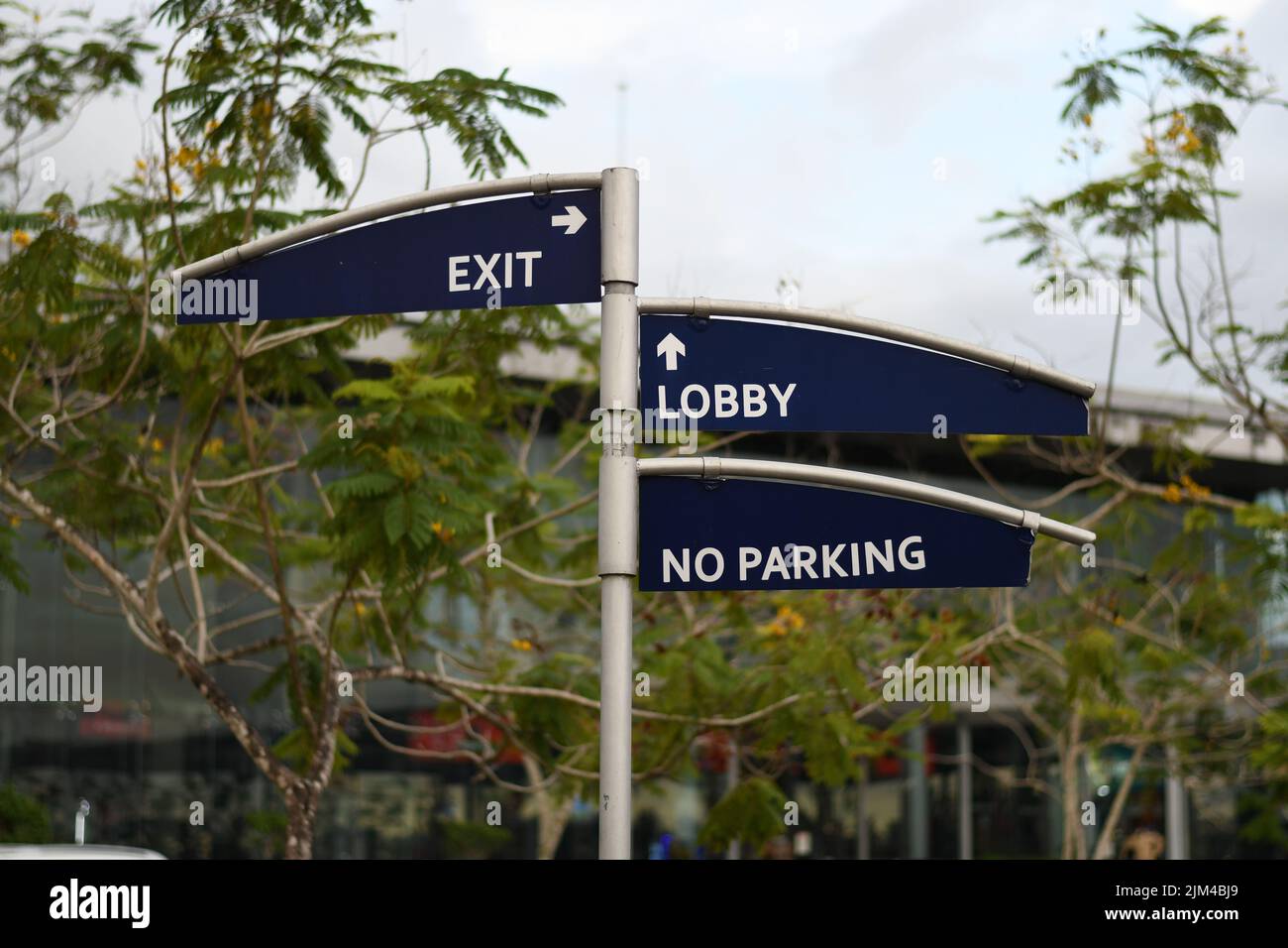 A closeup of exit, lobby, and no parking sign on post Stock Photo - Alamy