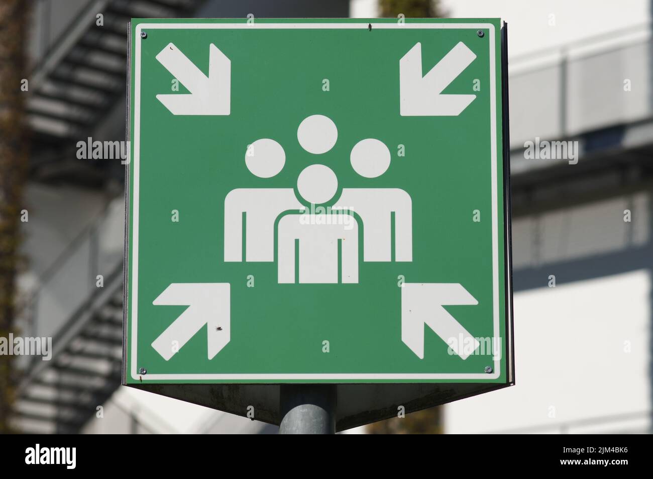 Sign for an evacuation assembly point on a university campus. Sign E007 ...