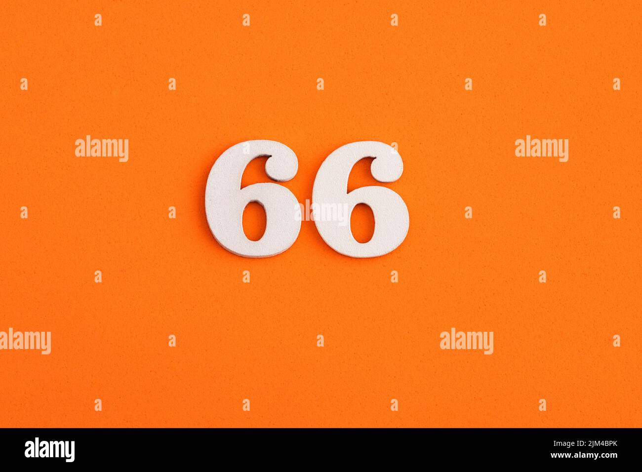 White wooden number 66 on eva rubber orange background Stock Photo - Alamy