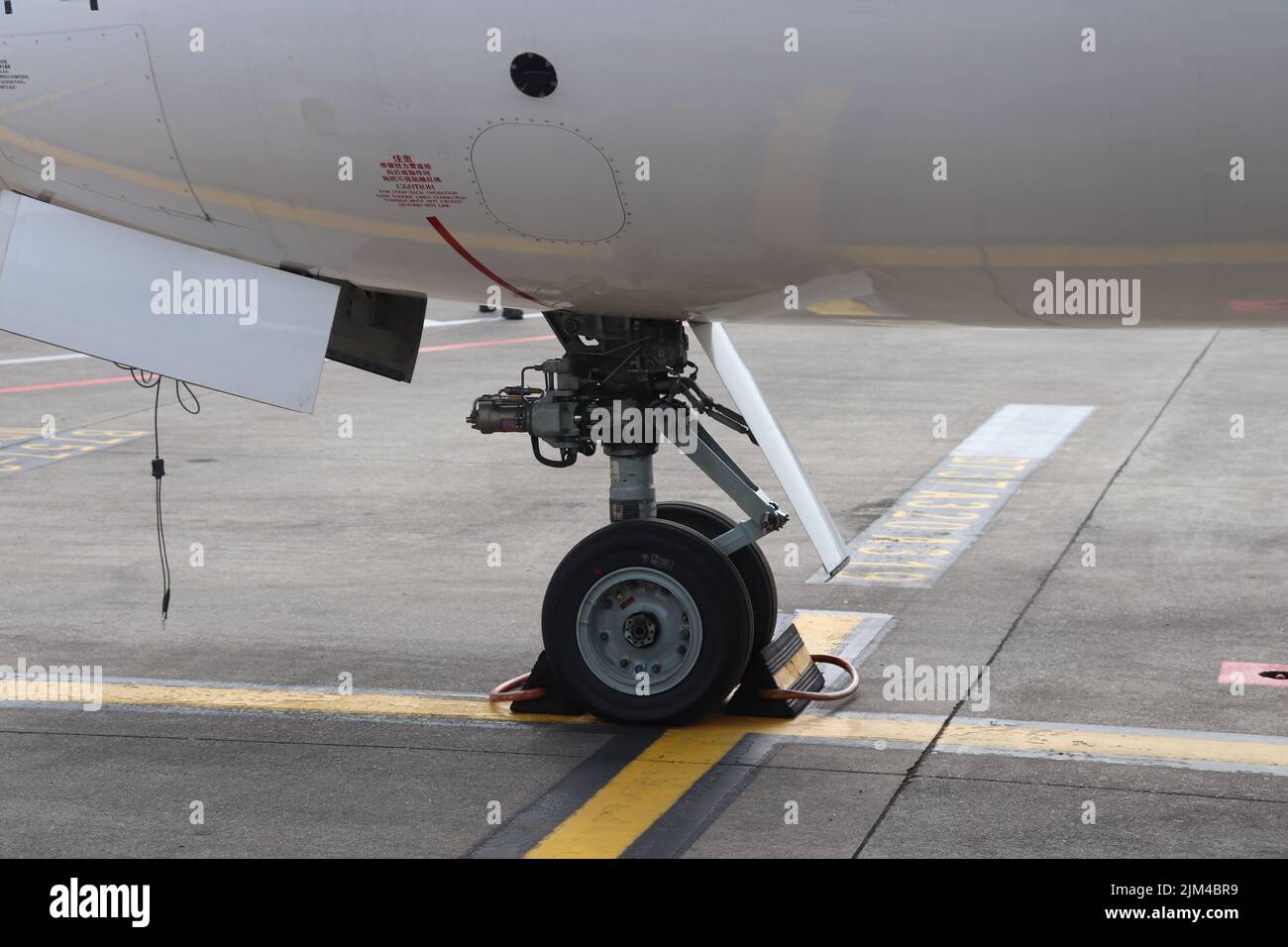 A closeup of an airplane wheel on the runway Stock Photo - Alamy