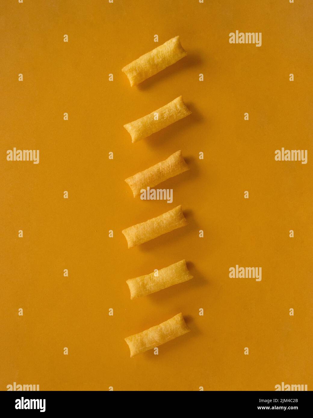 Yellow backdrop chips stick set in the middle of the image Stock Photo ...