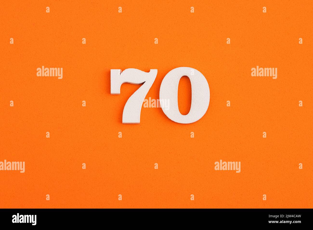 White wooden number 70 on eva rubber orange background Stock Photo - Alamy
