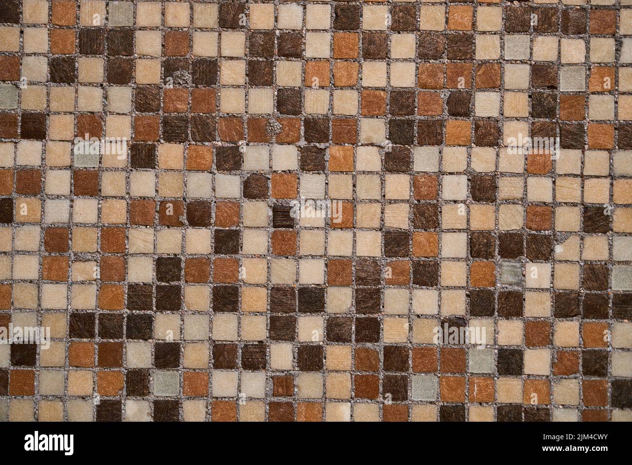 Small square ceramic tiles in different shades of brown with brown ...