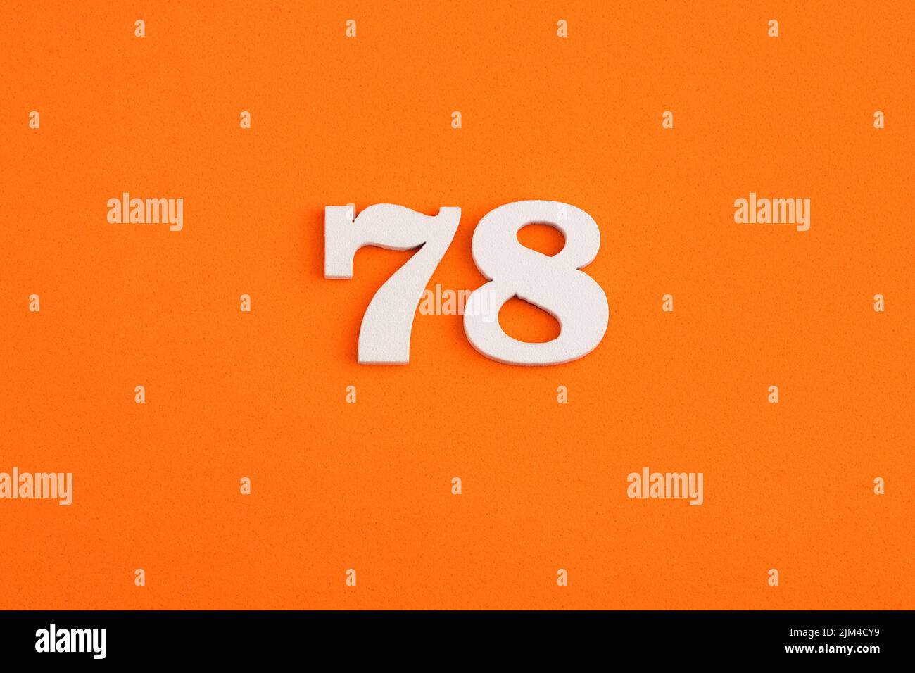White wooden number 78 on eva rubber orange background Stock Photo - Alamy