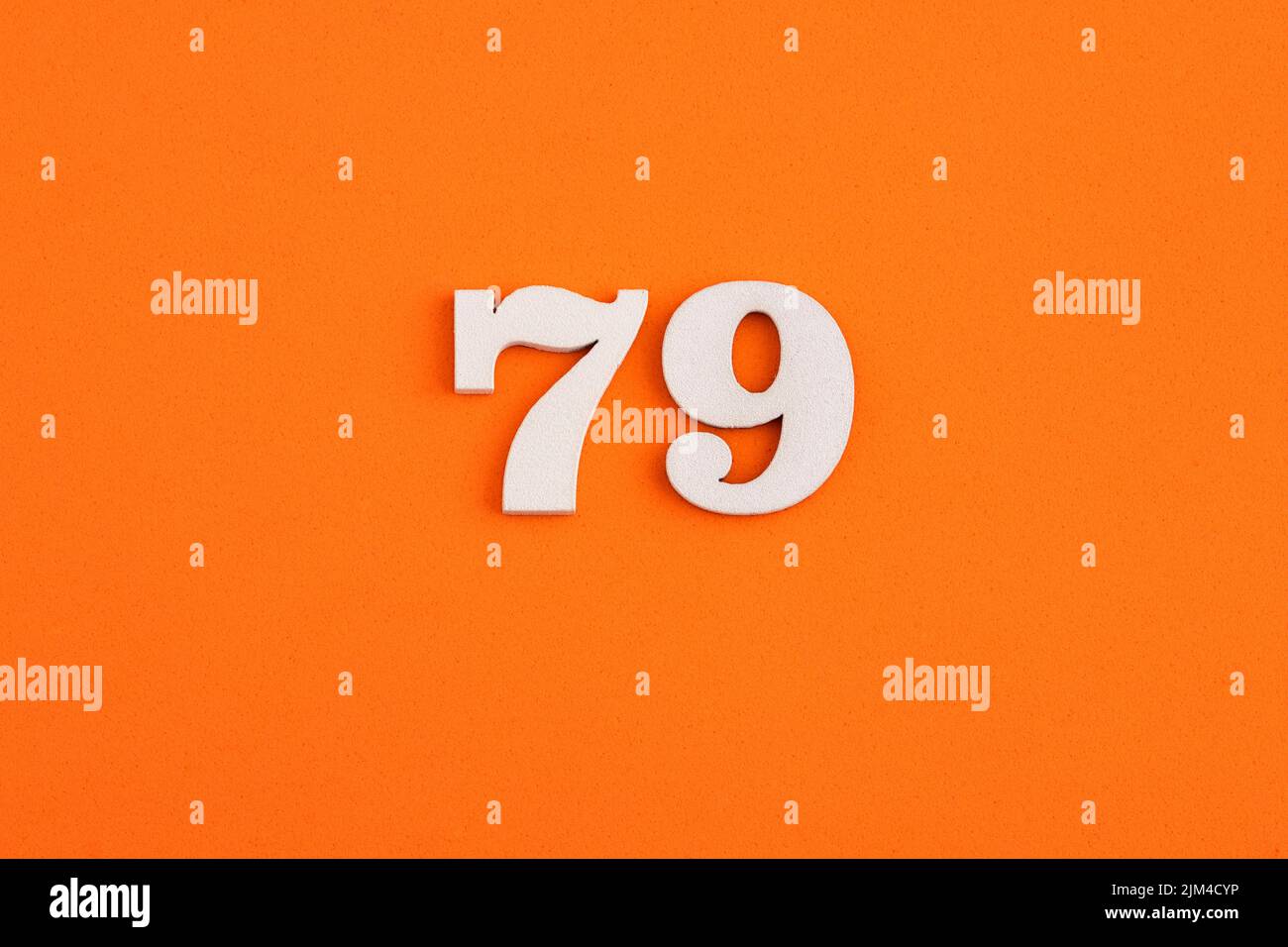 Number 79 - On orange foam rubber background Stock Photo - Alamy