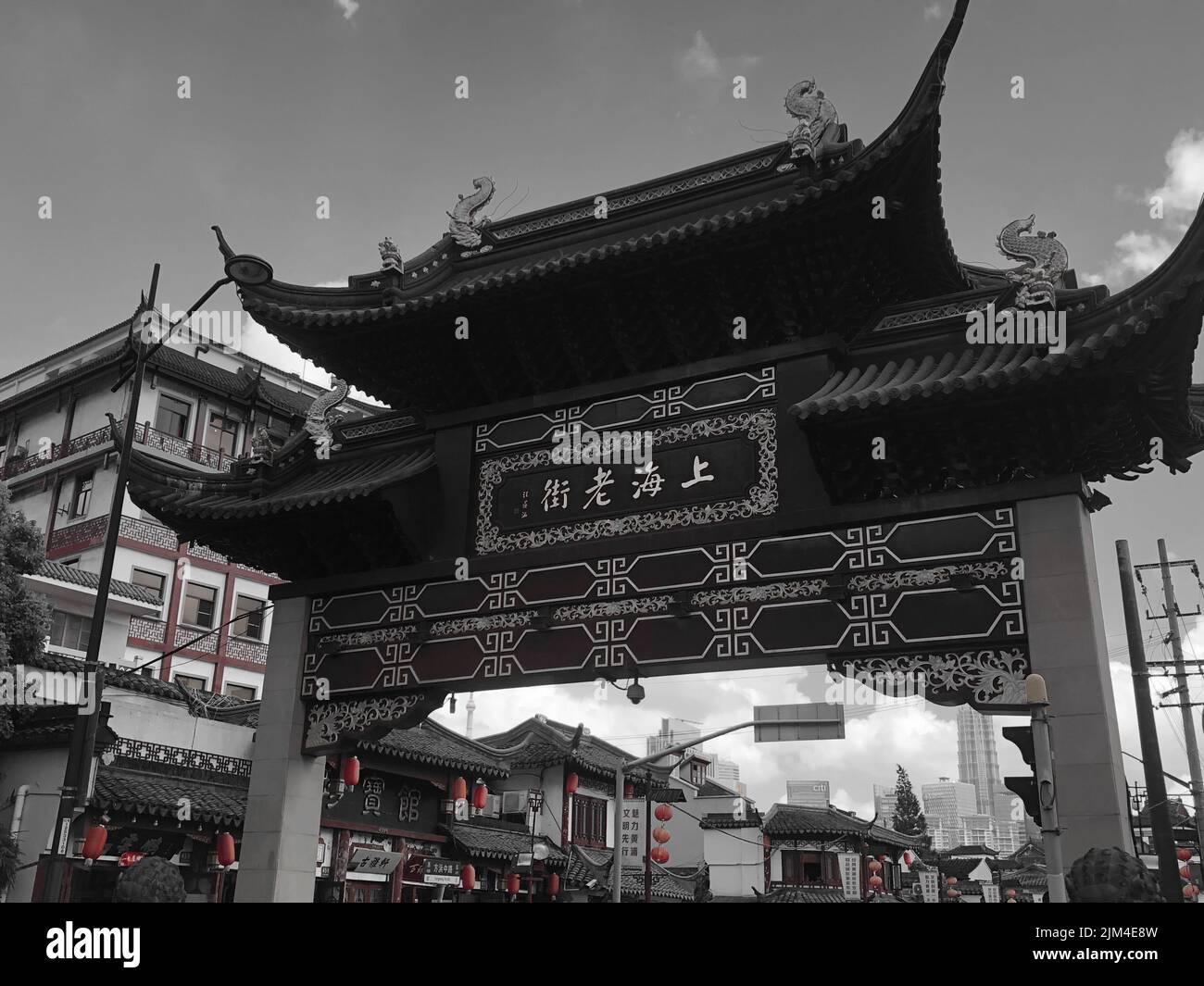 A grayscale shot of a street sign with Chinese writing on it in ...