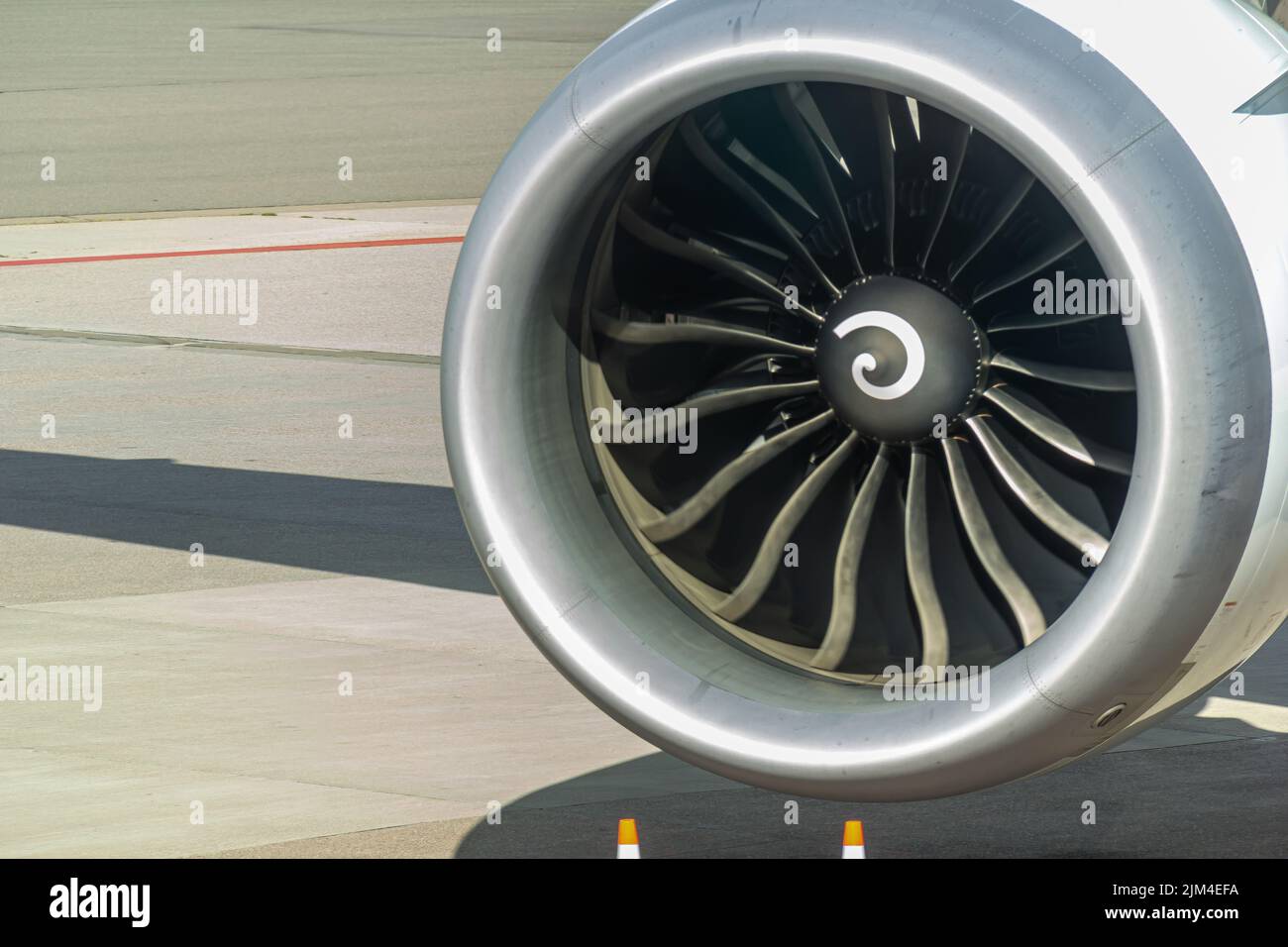 Aircraft parked on a runway, turbine in the foreground Stock Photo - Alamy
