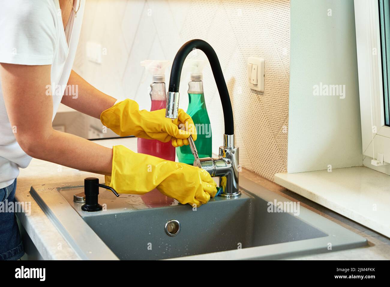 Person cleaning tap hi-res stock photography and images - Alamy