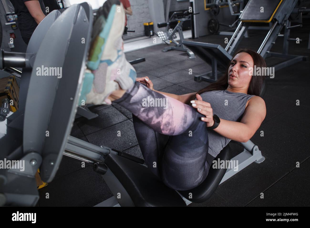 Woman using leg press machine hi-res stock photography and images - Alamy