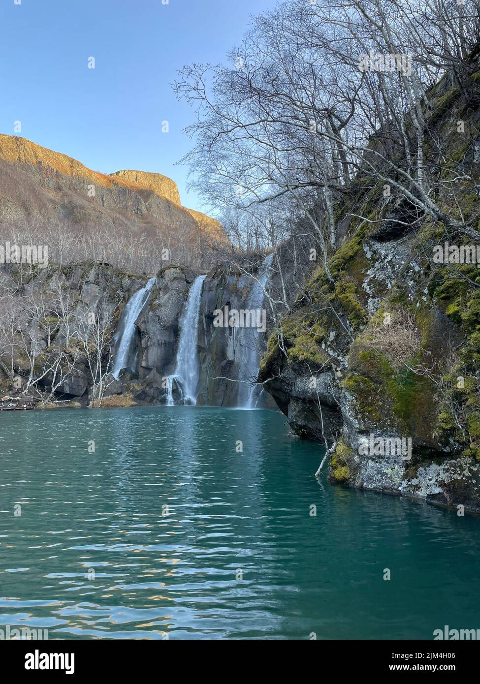 A beautiful view of a small waterfall flowing over the rocks Stock ...
