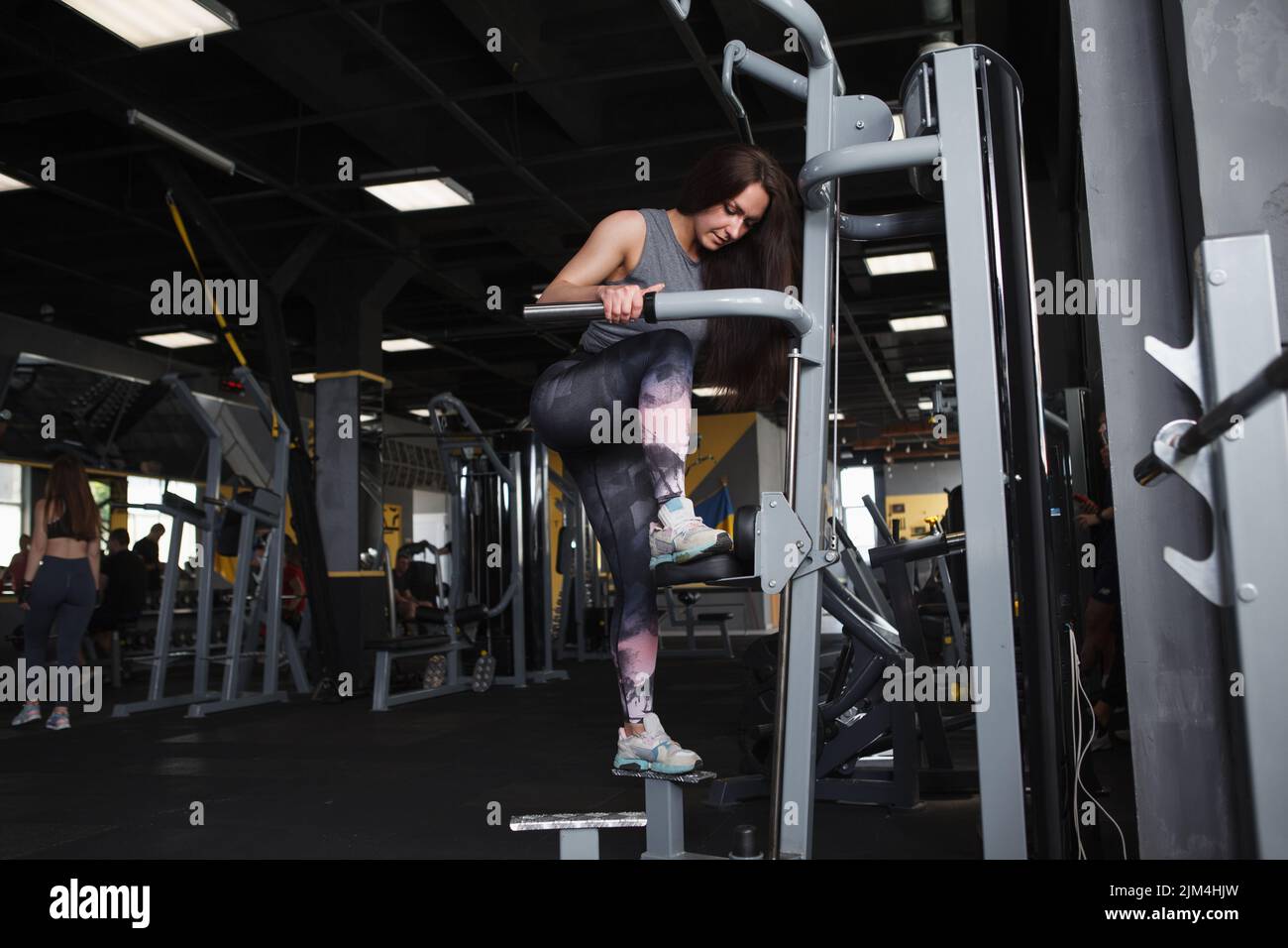 Full length shot of a sportswoman doing stepping buttocks exercise in a ...