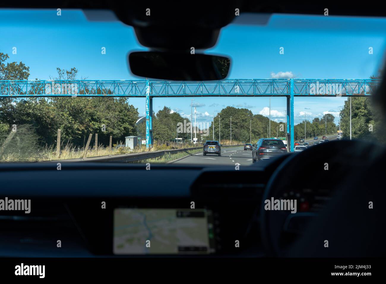 Young woman driving audi car in UK. Woman using navigation system while ... Young woman driving audi car in UK. Woman using navigation system while ...