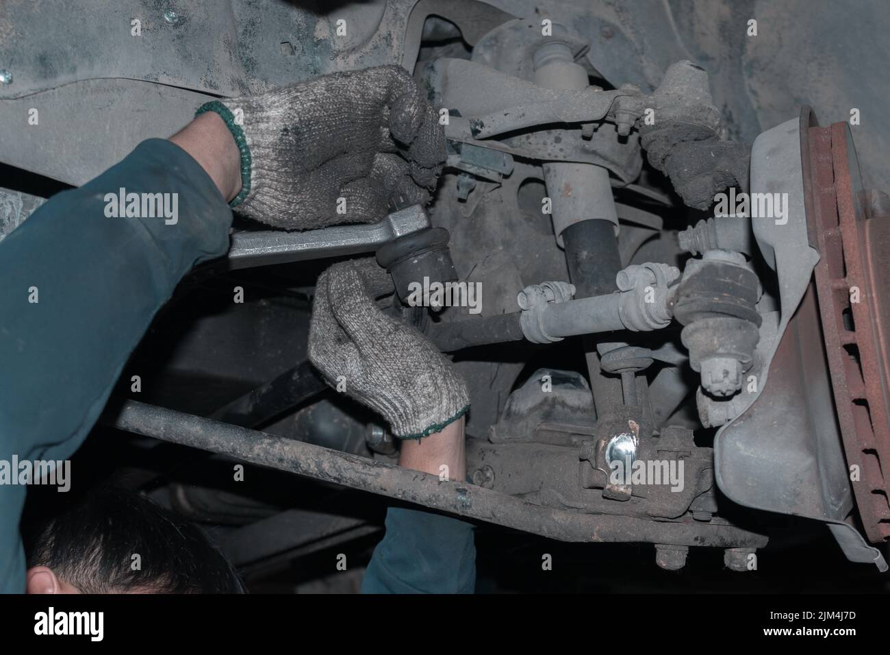 The mechanic is checking the engine. The mechanic is checking the ...