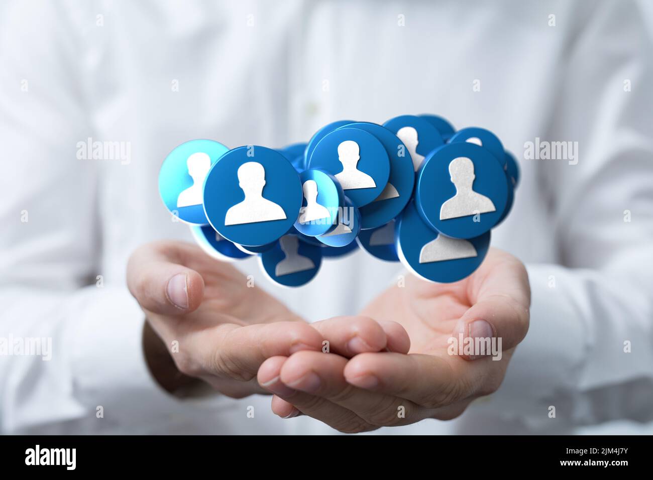A group of blue icons of people network on a male hands with shite ...