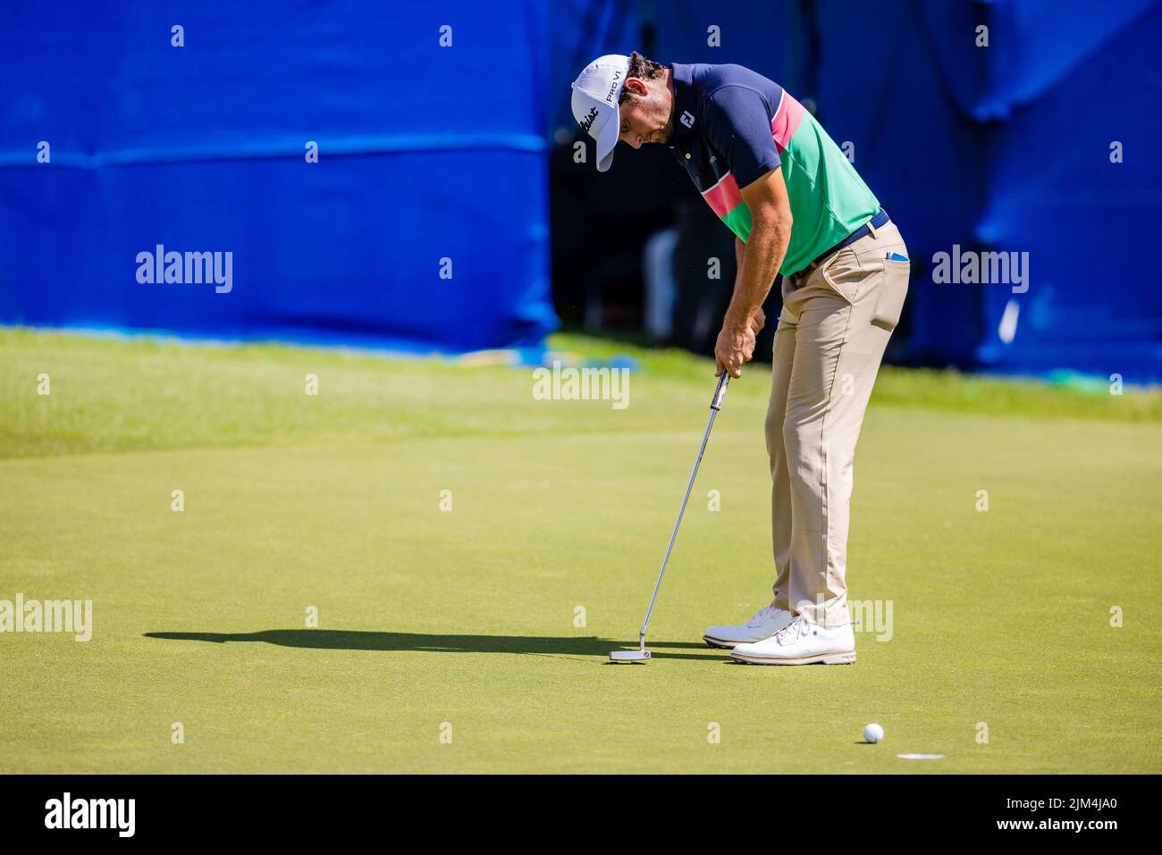 Greensboro, NC. August 4, 2022: Davis Riley taps in a birdie putt on 17 ...