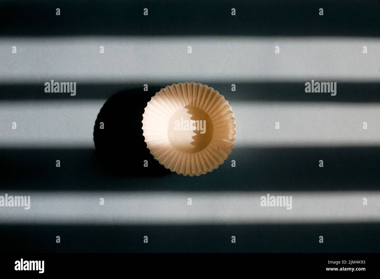 empty baking paper cups. white cookie paper cases isolated on blue ...