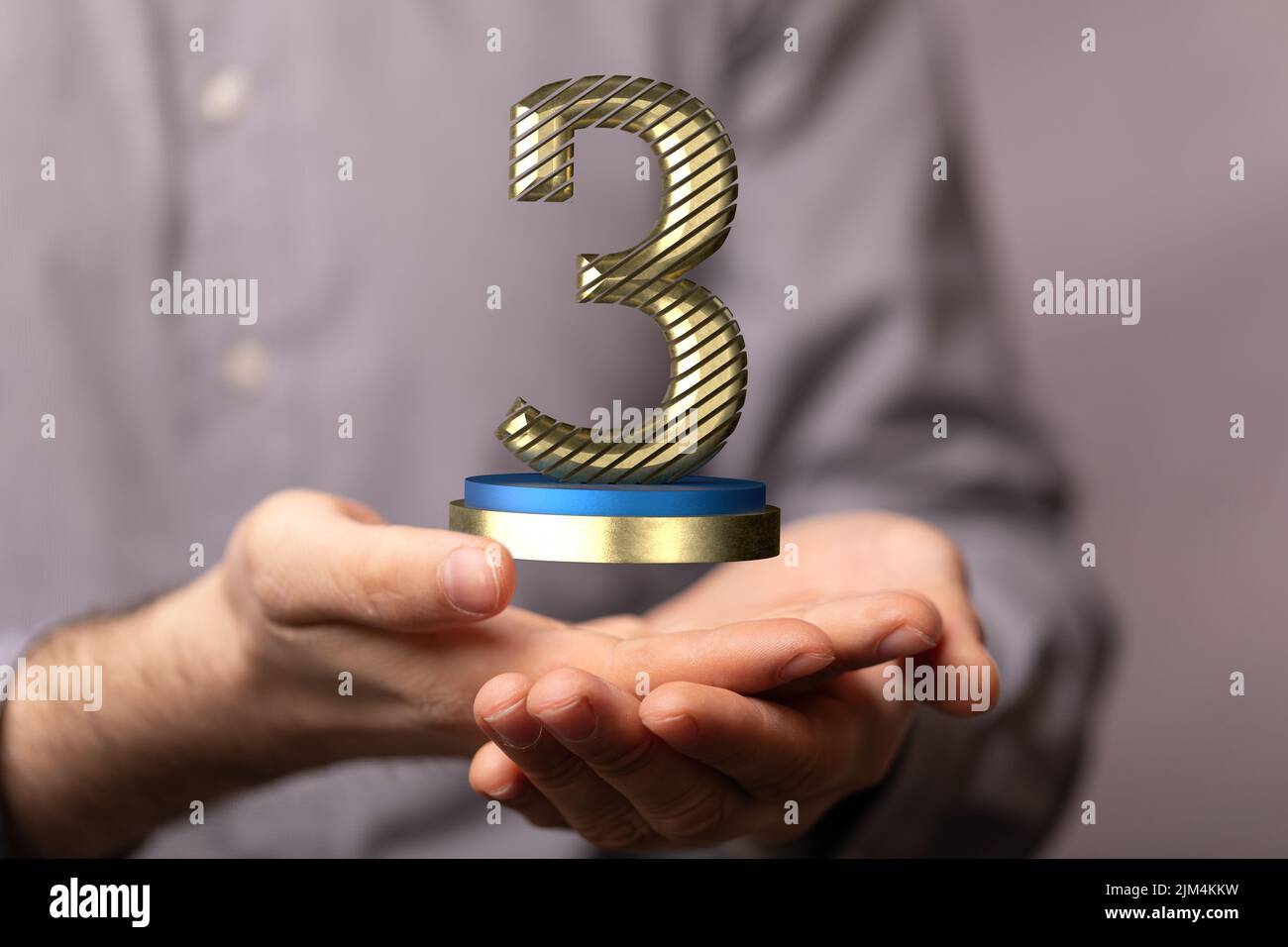 The third place awart floating in the air above person's hands Stock ...