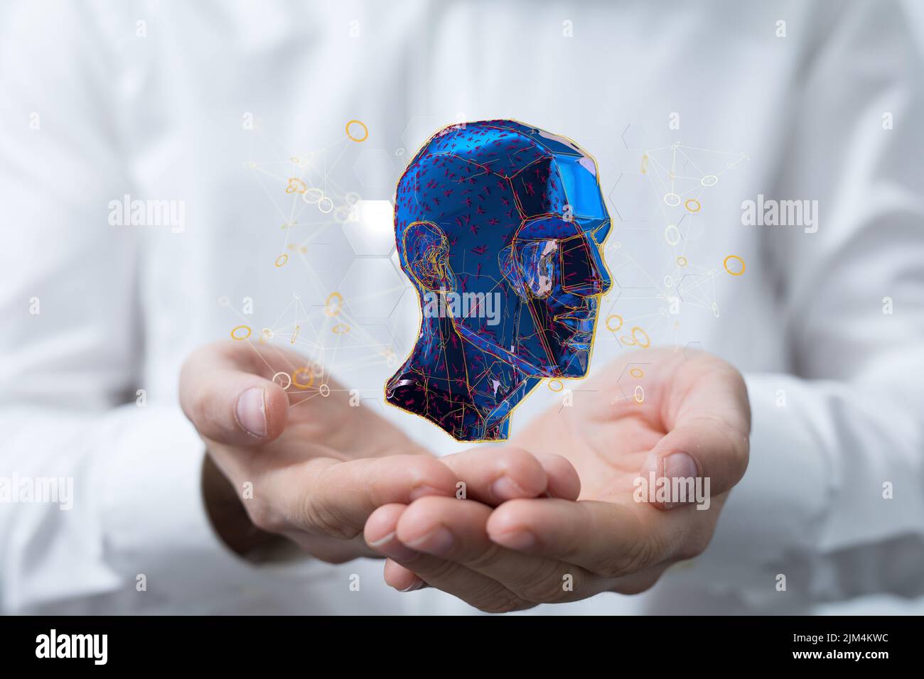 A person's hands with an illustrative cyber human head floating above ...