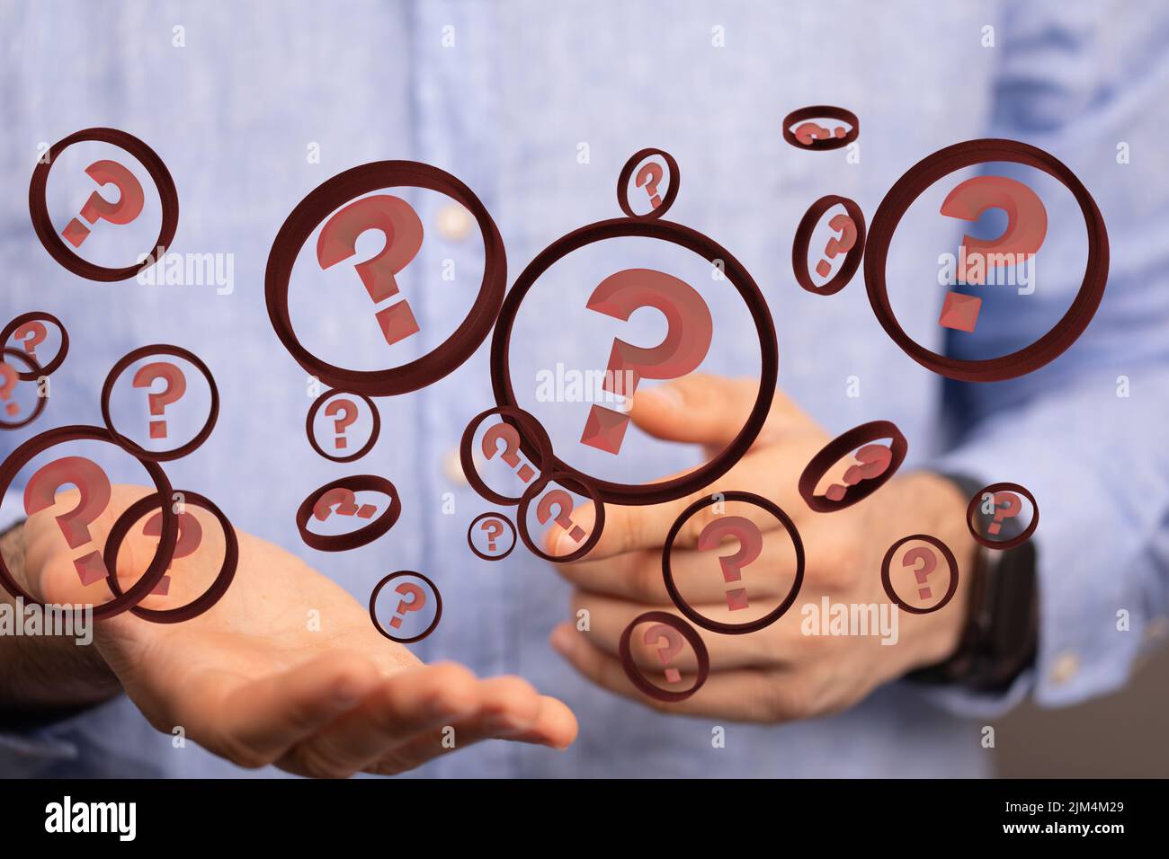 A person's hand with illustrative question mark icons floating above a hand Stock Photo - Alamy