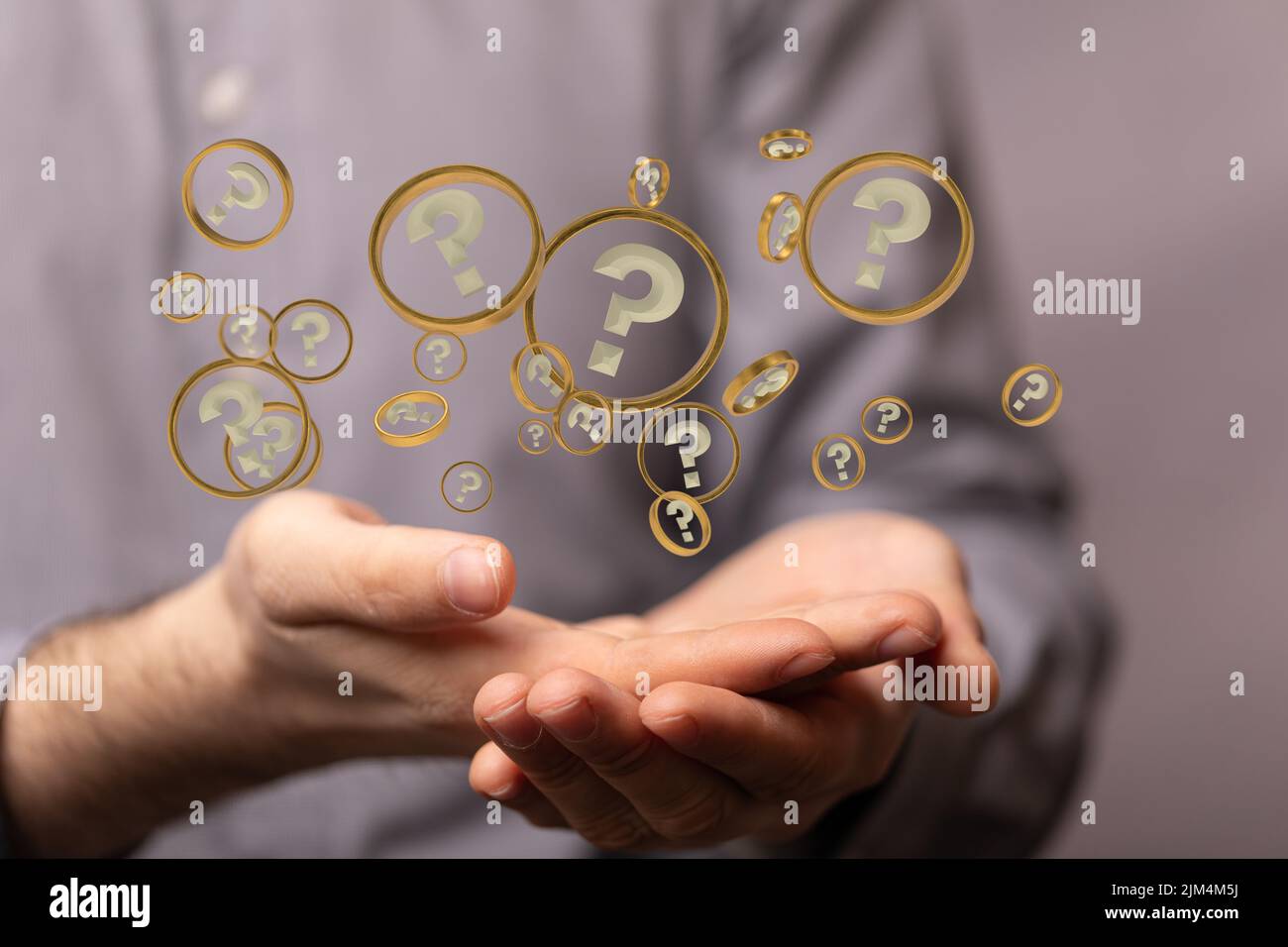 A person's hand with illustrative question mark icons floating above hands Stock Photo - Alamy