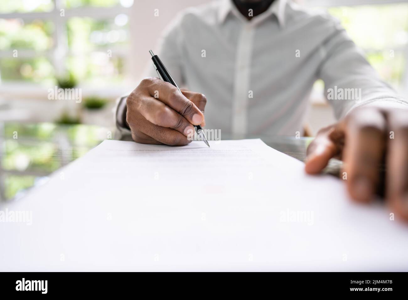 Agreement Form Signature. Hand Signing Paper Using Pen Stock Photo - Alamy