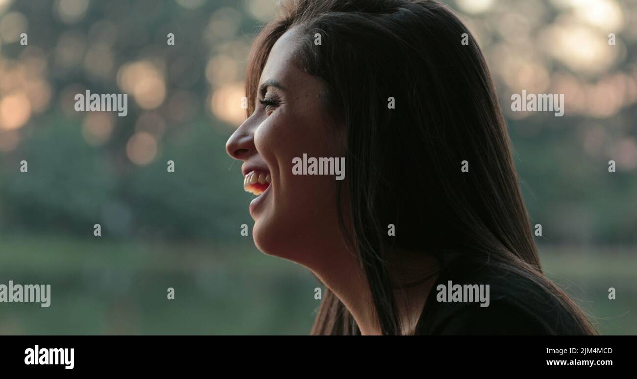 Candid profiles of friends speaking outdoors at the park, authentic ...