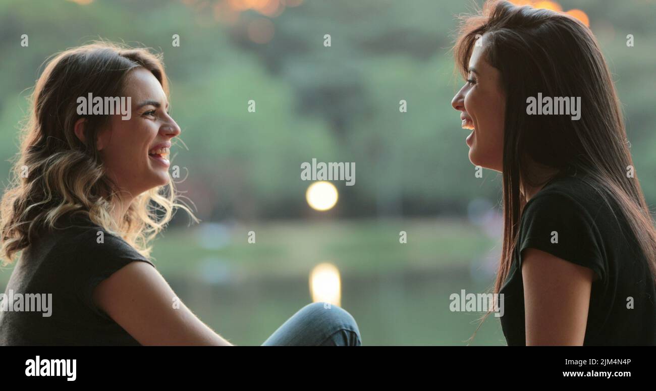 Friends gossiping and exchanging ideas in conversation outdoors in the ...