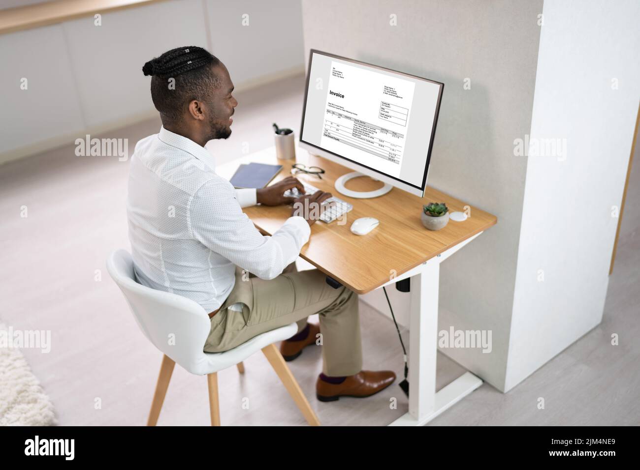 African American Using Computer For Online Invoice Calculation Stock ...
