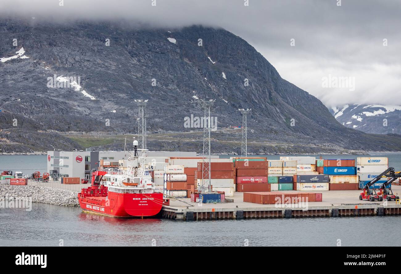 Containers stacked up at the port in Nuuk with snow capped mountains in ...