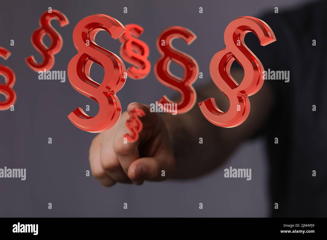 A male touching red law paragraph symbols in gray background Stock ...