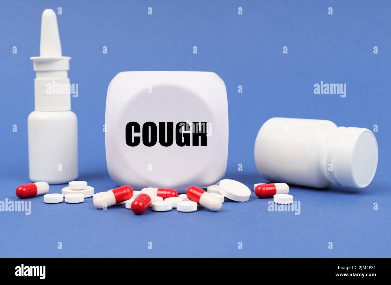 Medical concept. On the blue surface of the pill, capsule, spray, jar ...