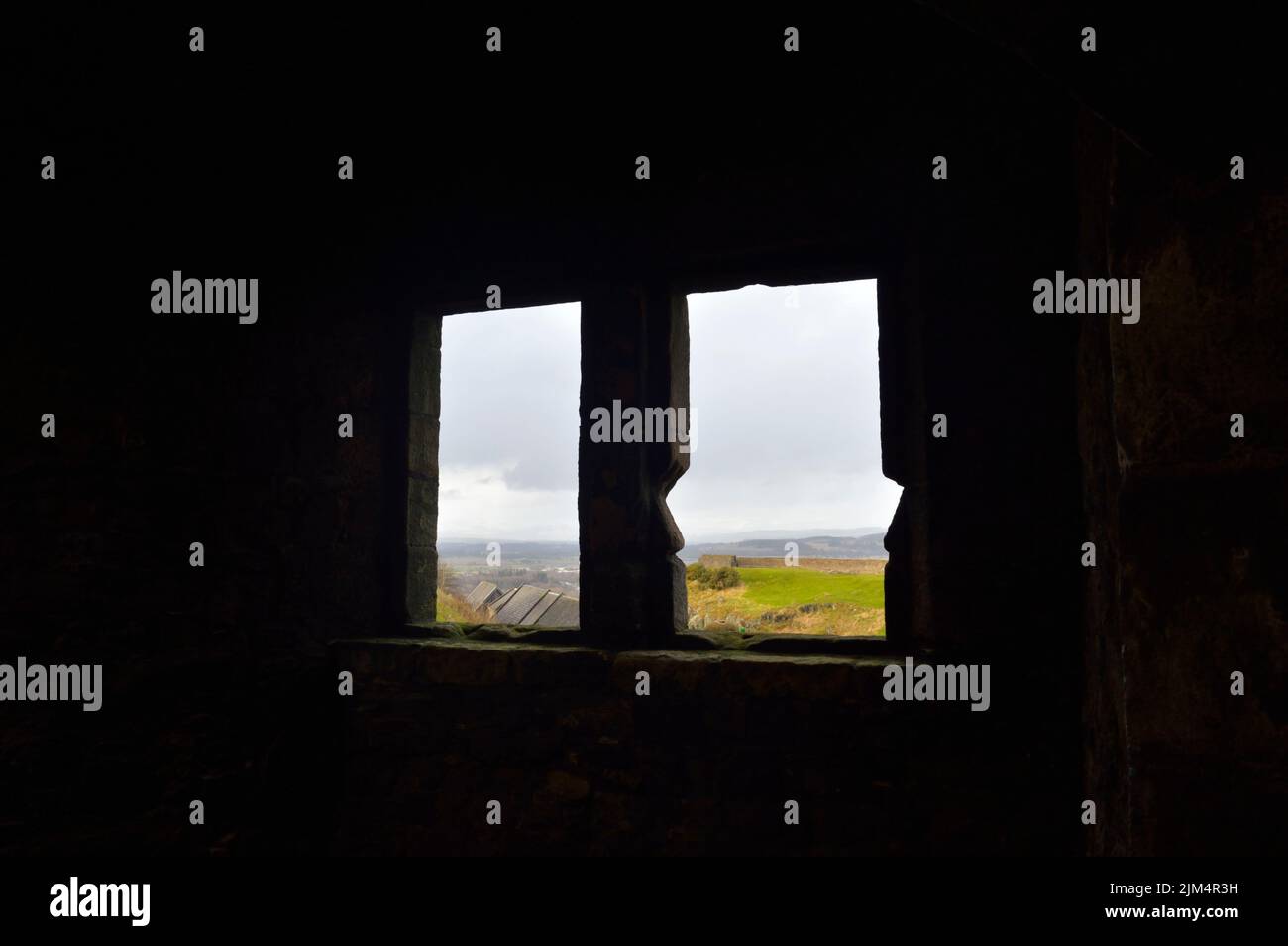 A dark rustic room with a light view from broken windows Stock Photo ...