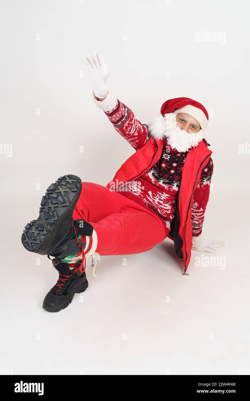 Christmas holidays concept. Cheerful Santa Claus dances a semi-squat ...