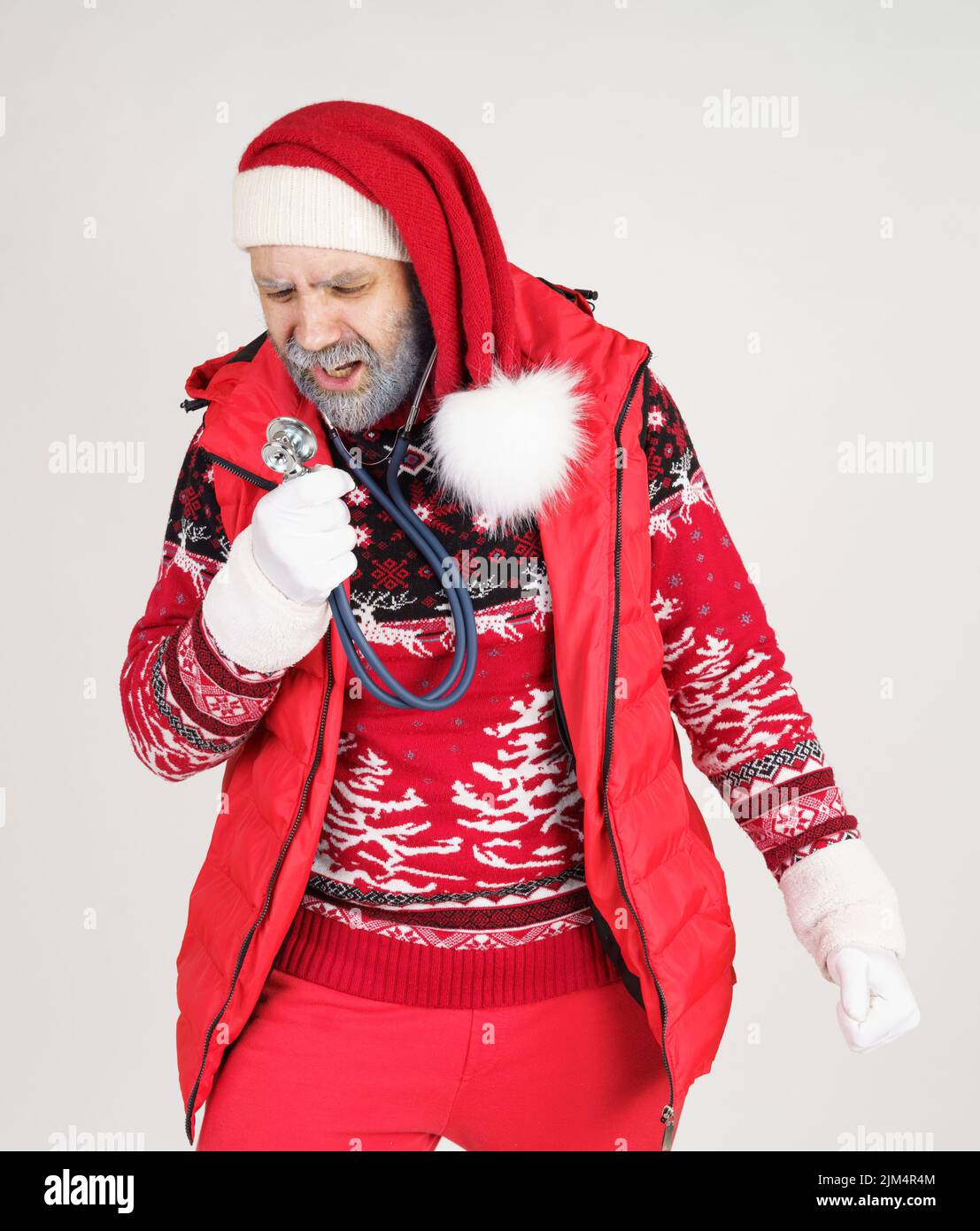 Christmas holidays concept. Santa Claus sings songs into a stethoscope ...