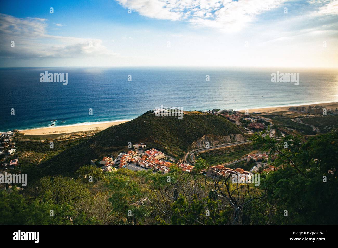 The beautiful view of the green shoreline and the blue sea. Cabo San ...