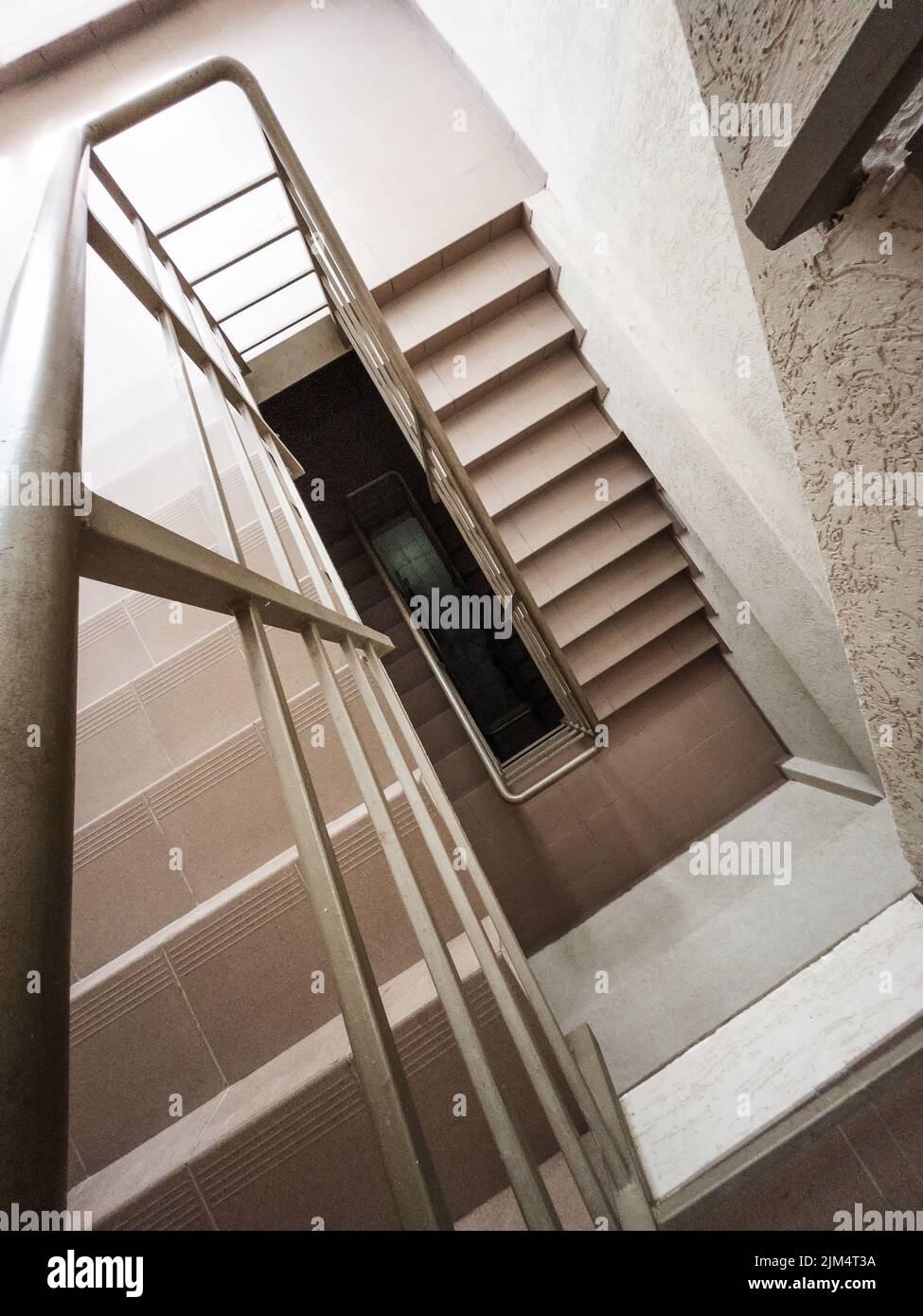 A flight of stairs with steps and handrails from top to bottom ...