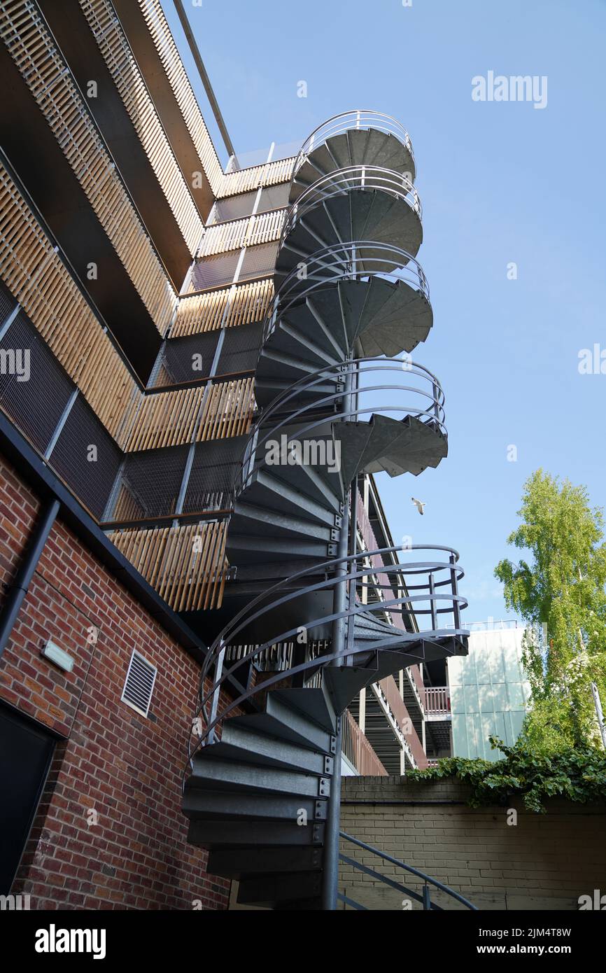 A vertical low angle spiral fire escape stairs Stock Photo - Alamy