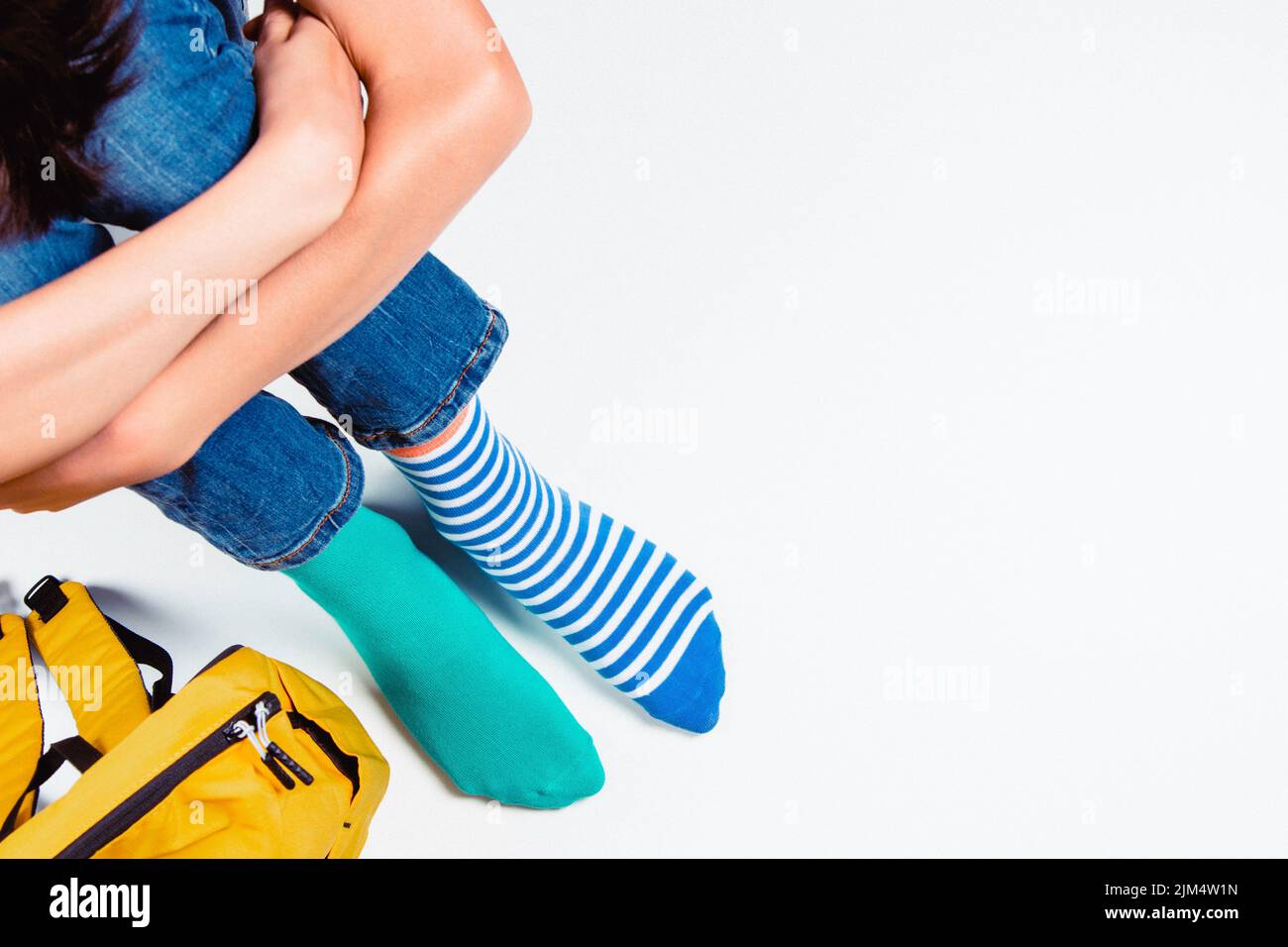 Kid wearing different pair of socks. Child foots in mismatched socks ...