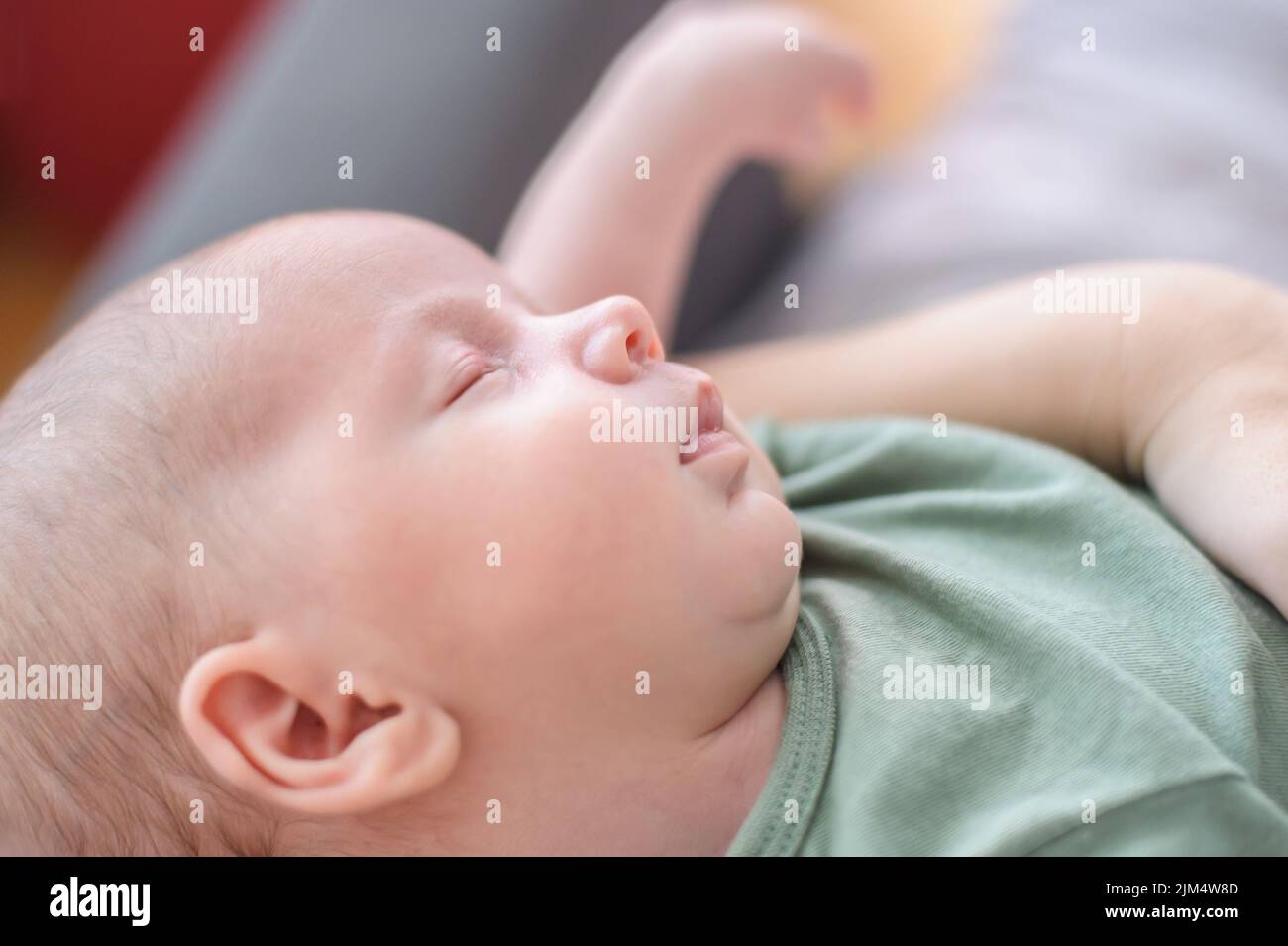 Cute detail macro portrait view of peaceful baby head face, calm sleeps ...