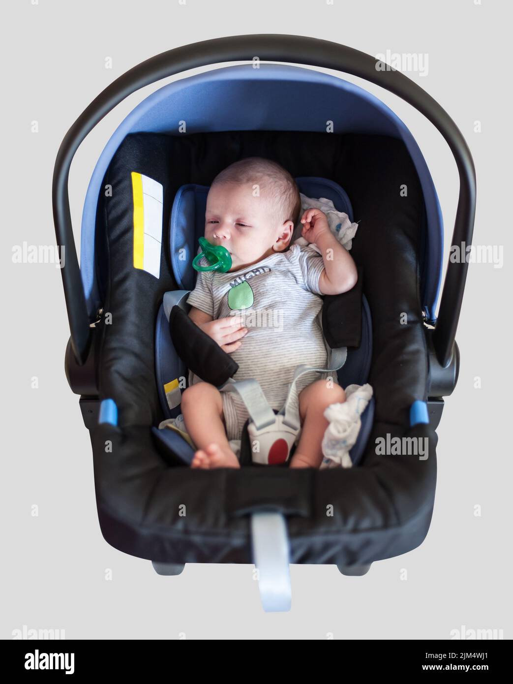 Cute little peaceful baby in his egg shell stroller car seat. Clipping ...