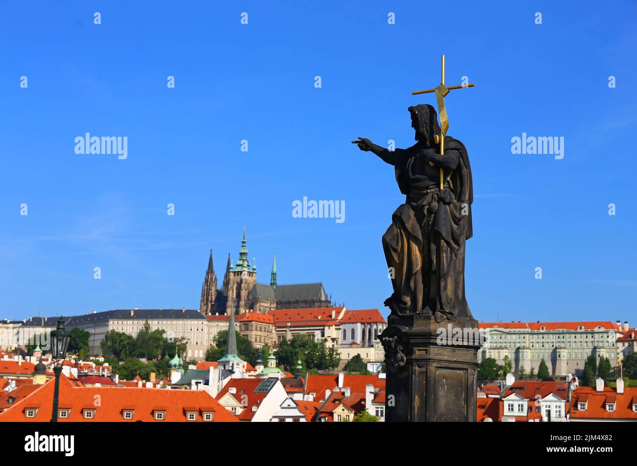 A closeup of the black Jesus Christ statue under a blue sky in the ...