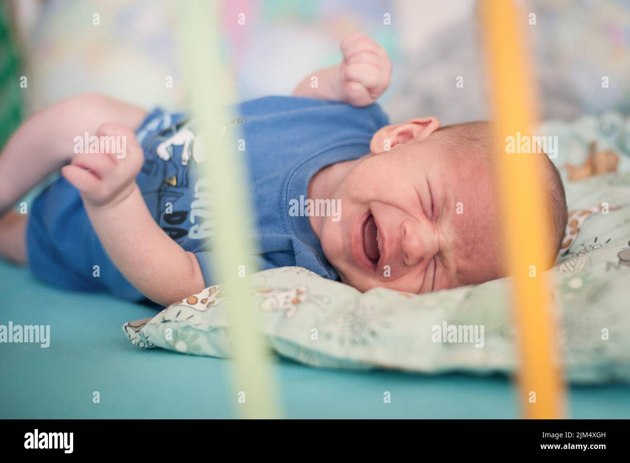 Sweet and cute small little newborn baby is hungry and upset and cry ...