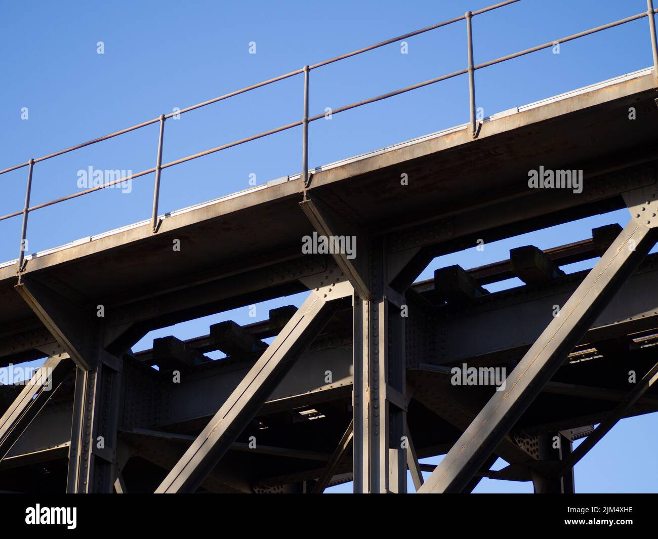 A low angle of a wooden walkway under a clear blue sky Stock Photo - Alamy