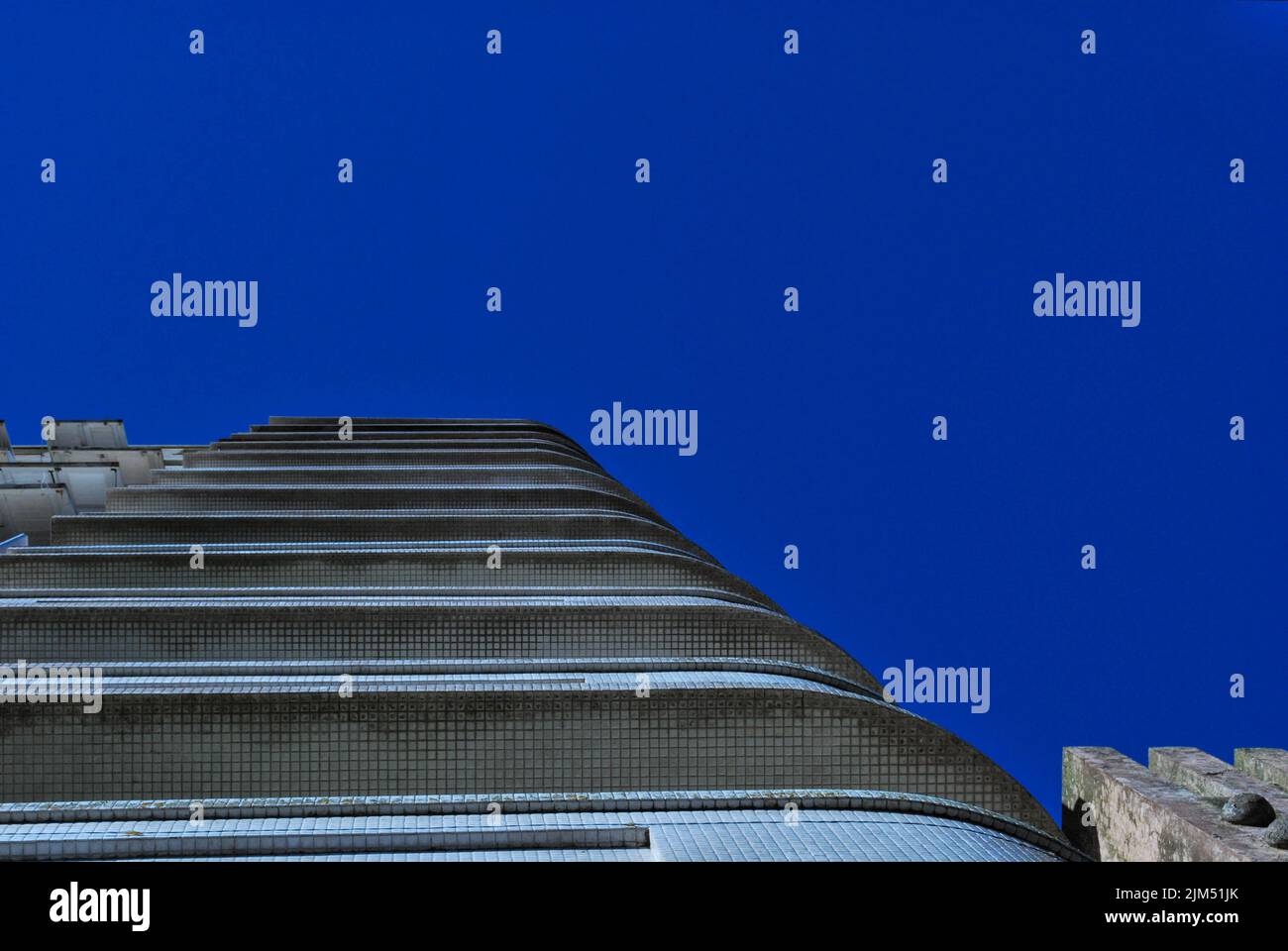 balconies of a white tile building seen from below Stock Photo - Alamy