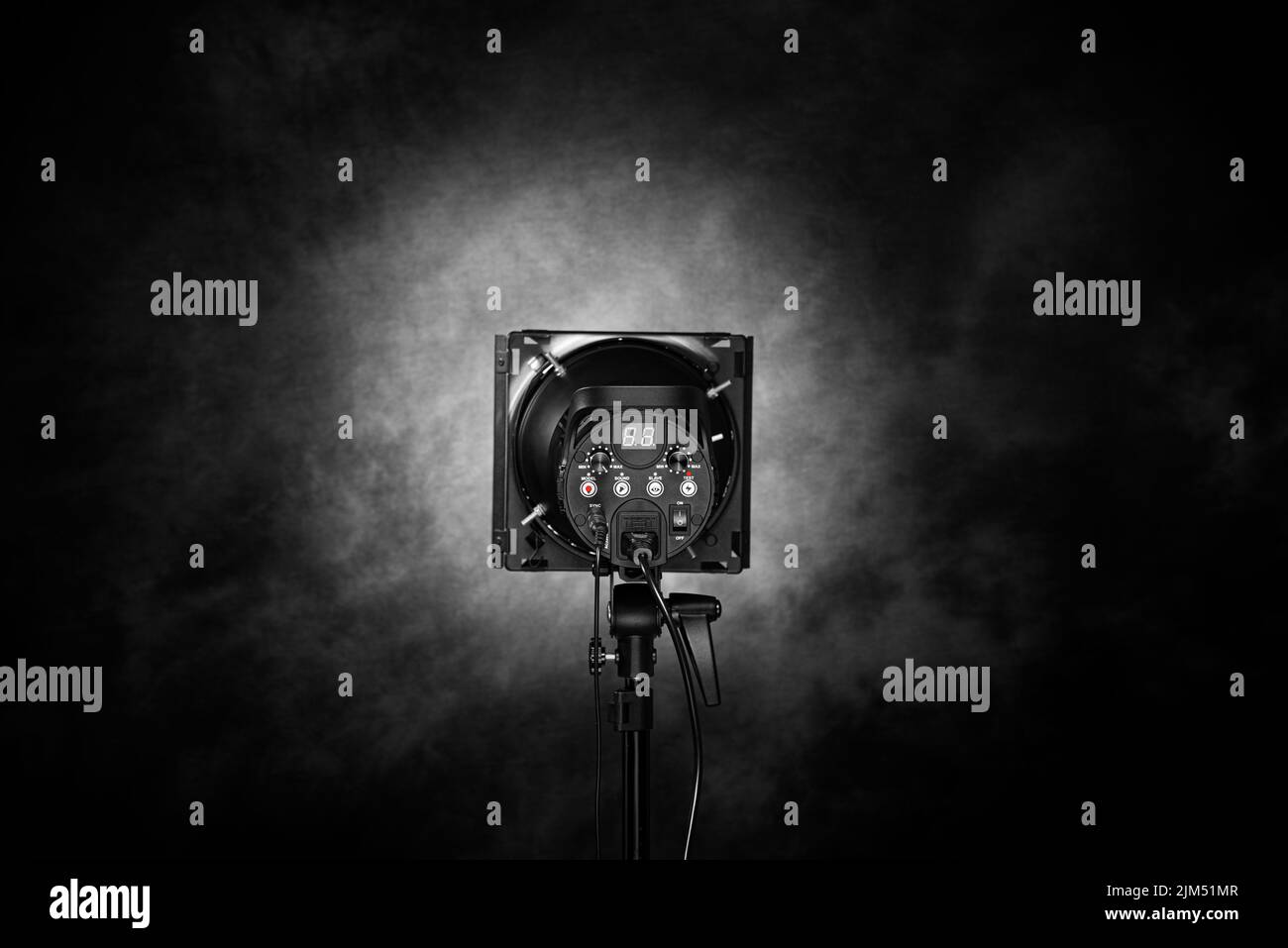 Studio flash on a dark background Stock Photo - Alamy